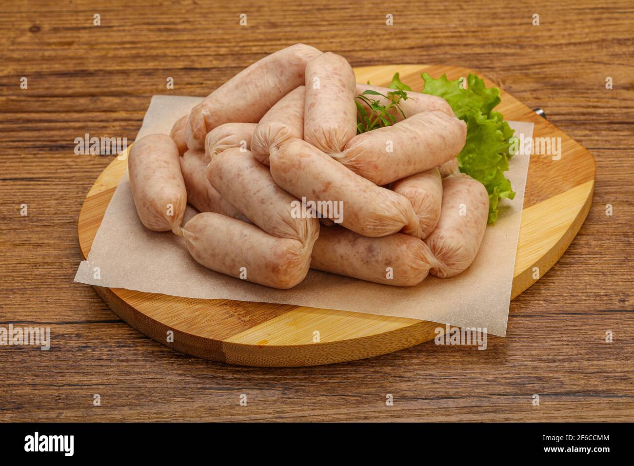 Raw natural chicken baby sausages for roast Stock Photo - Alamy
