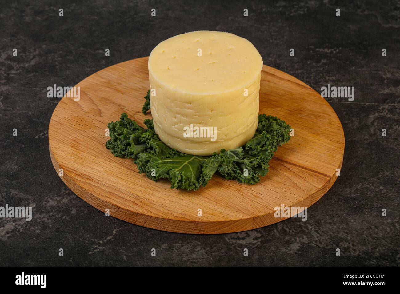 Yellow round dairy soft cheese piece Stock Photo - Alamy