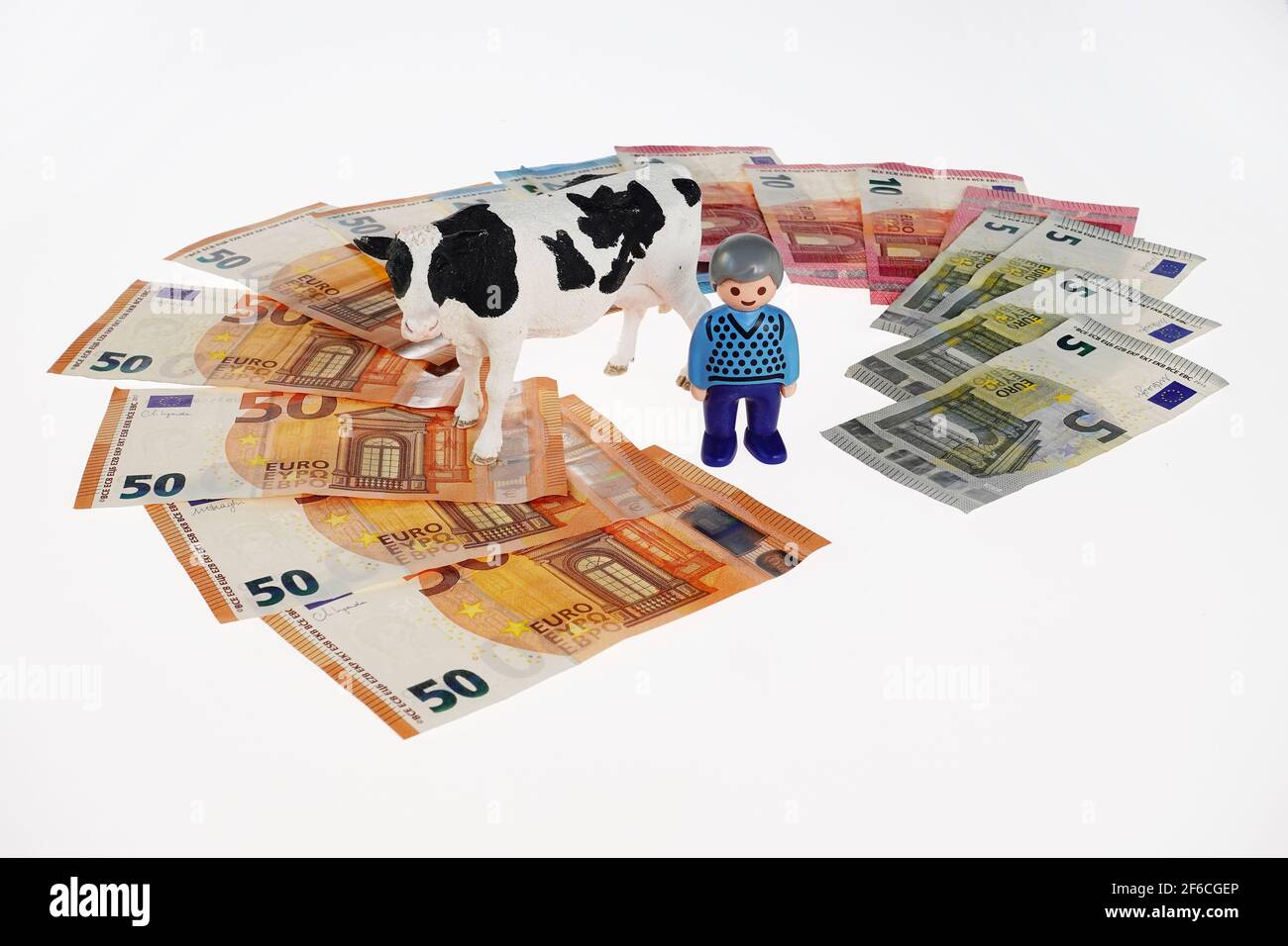 A Cow, farmer and Money Stock Photo - Alamy