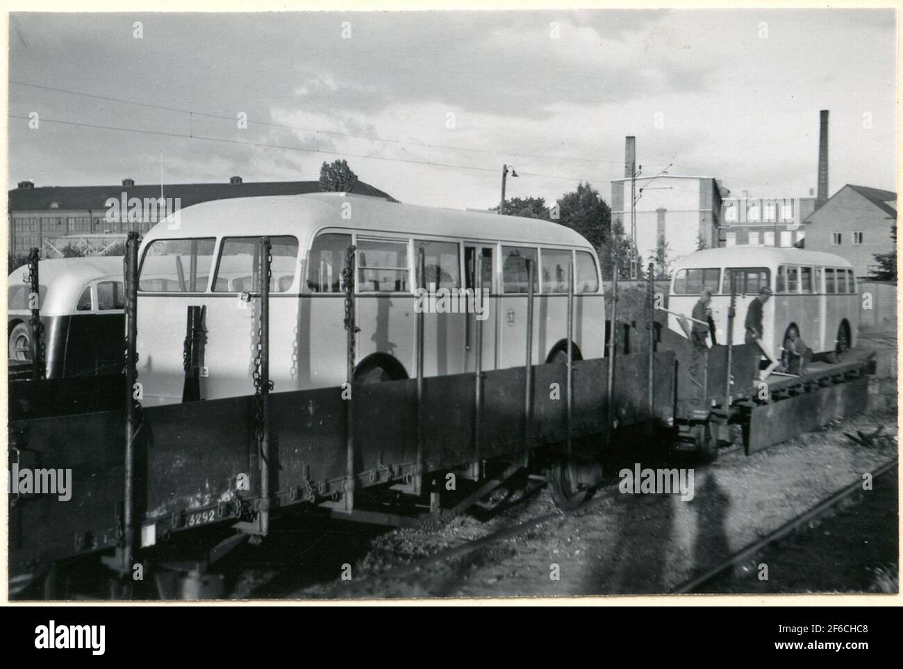 Buses and trailers are transported by rail Stock Photo - Alamy