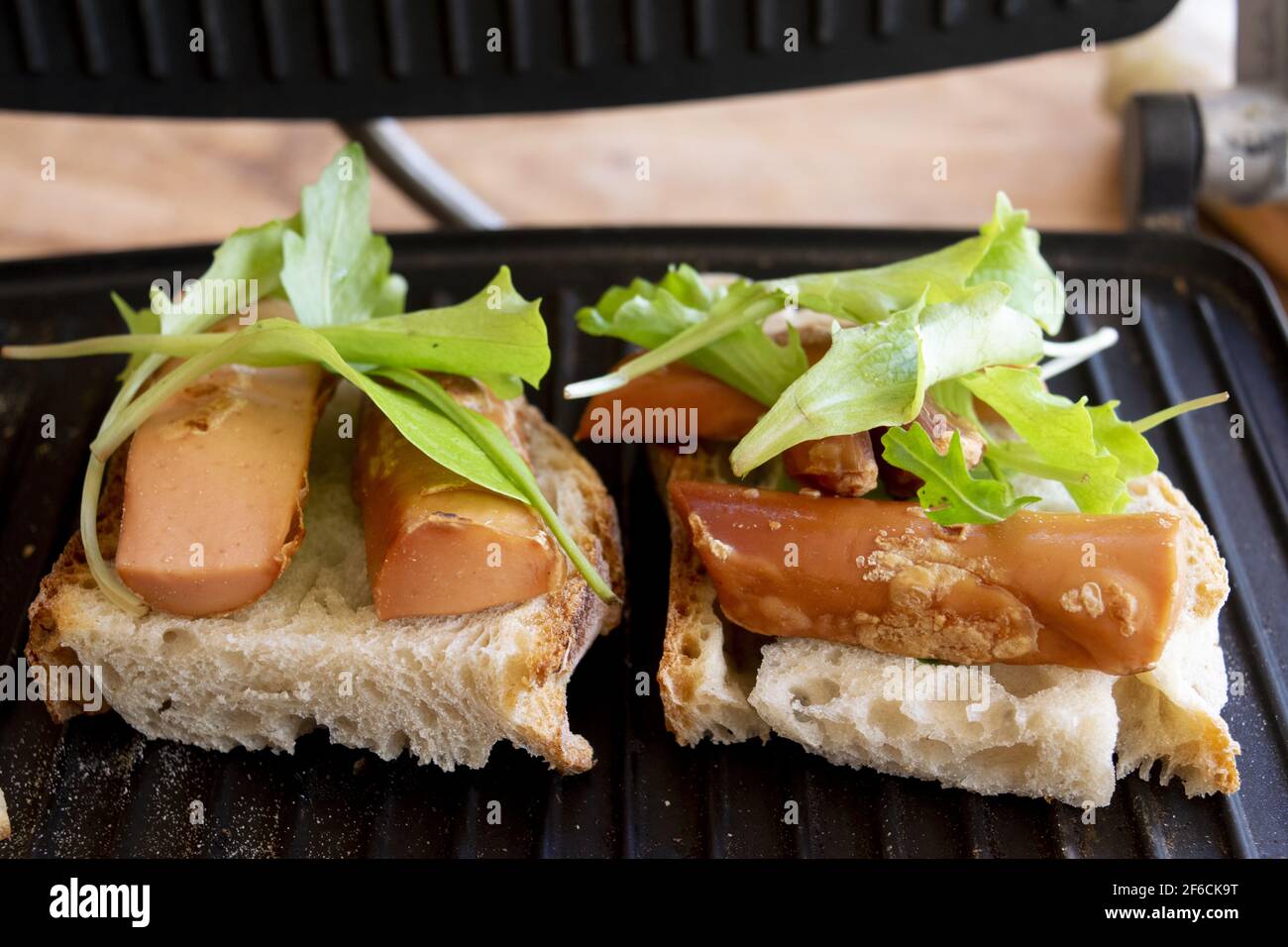 preparing toast made with bread wurstel and mixed green salad Stock ...
