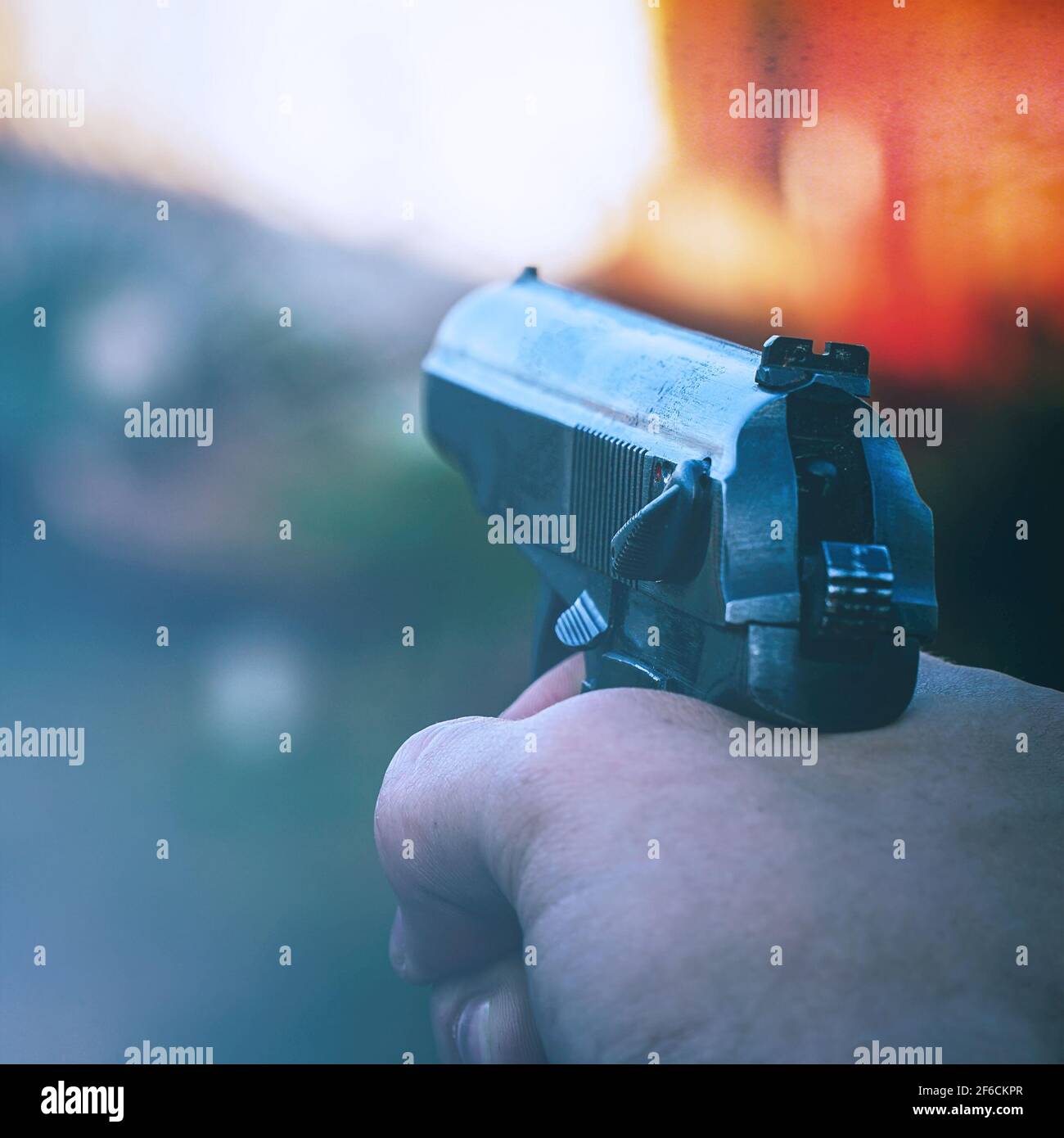 Gun in the hands of a man Stock Photo - Alamy