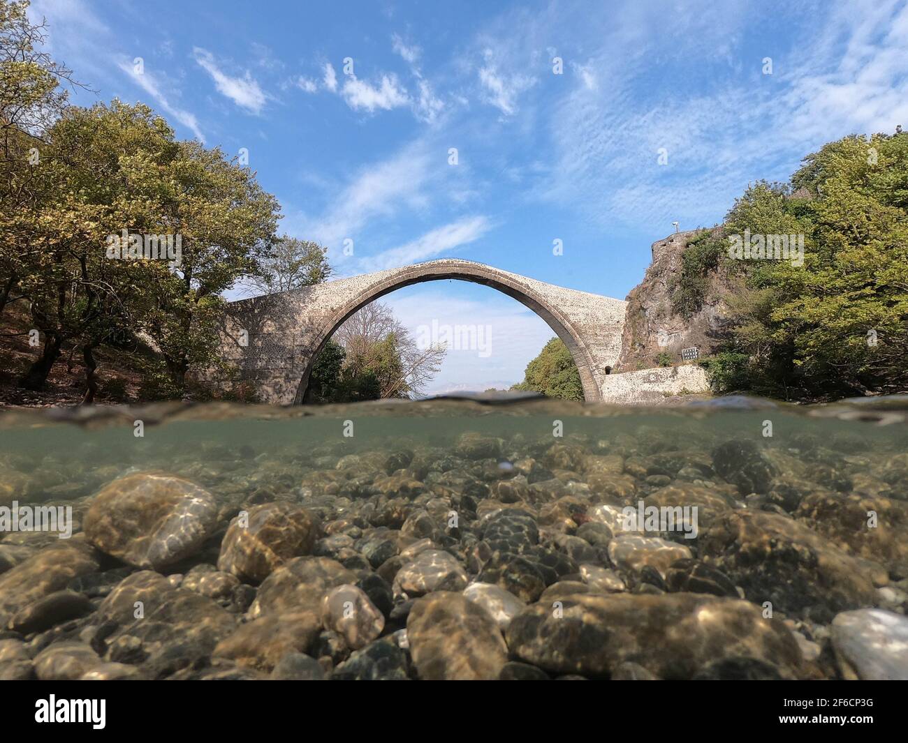 Old stone bridge of Konitsa, Aoos river, half underwater view, Epirus ...