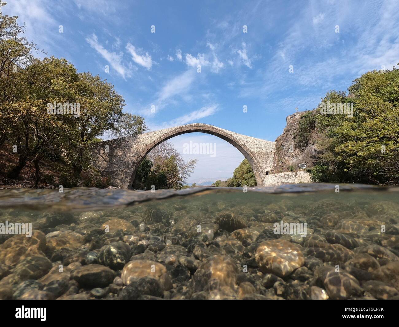 Old stone bridge of Konitsa, Aoos river, half underwater view, Epirus ...