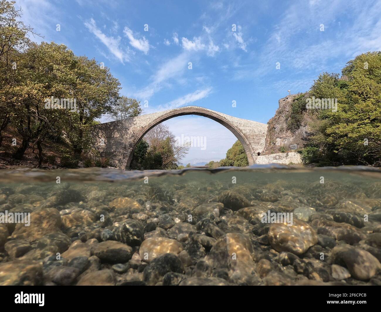 Old stone bridge of Konitsa, Aoos river, half underwater view, Epirus ...