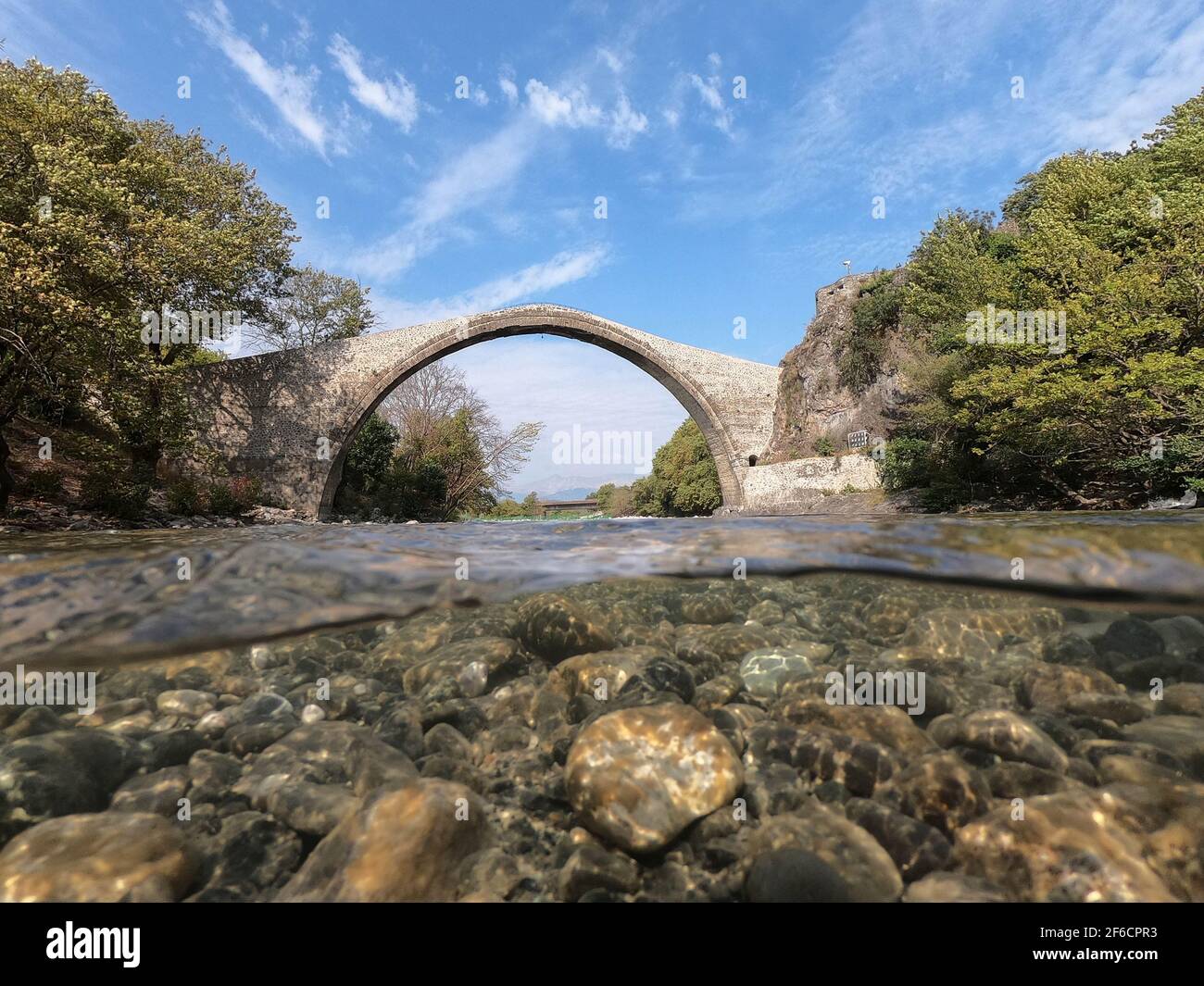 Old stone bridge of Konitsa, Aoos river, half underwater view, Epirus ...