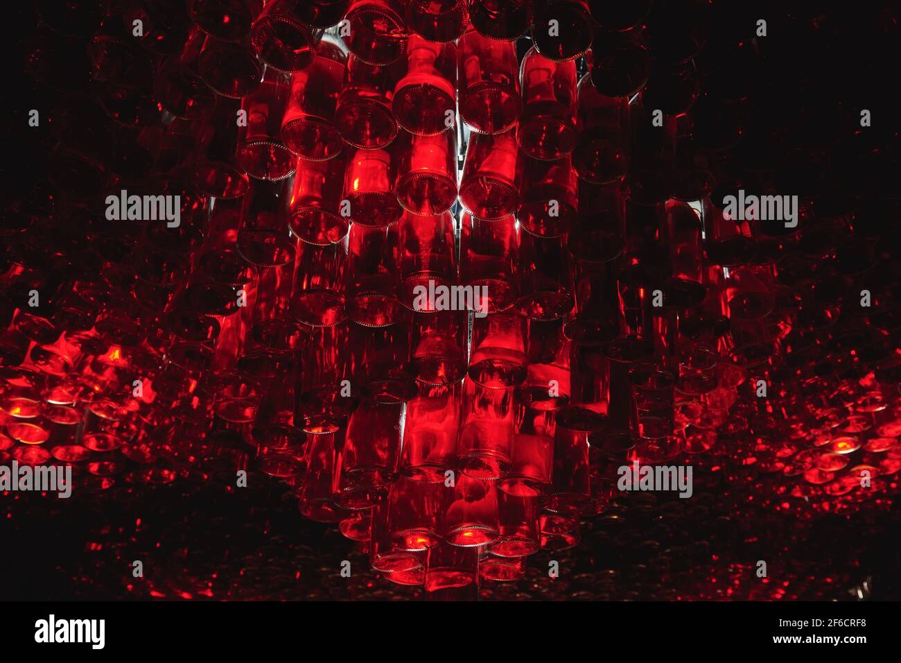 Ceiling of bar made from many bottles with red liquid. Atmosphere bar ...