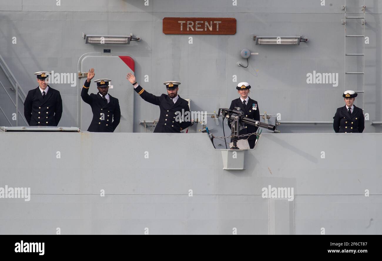 Ship's company wave from the Royal Navy patrol ship HMS Trent as she ...