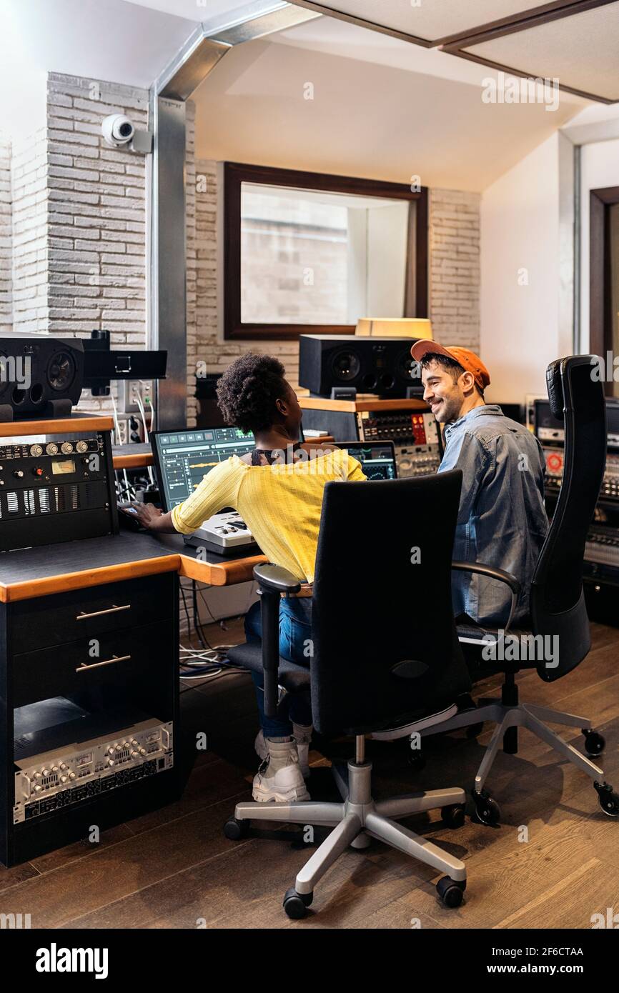 Stock photo of black woman working with male producer in music studio ...