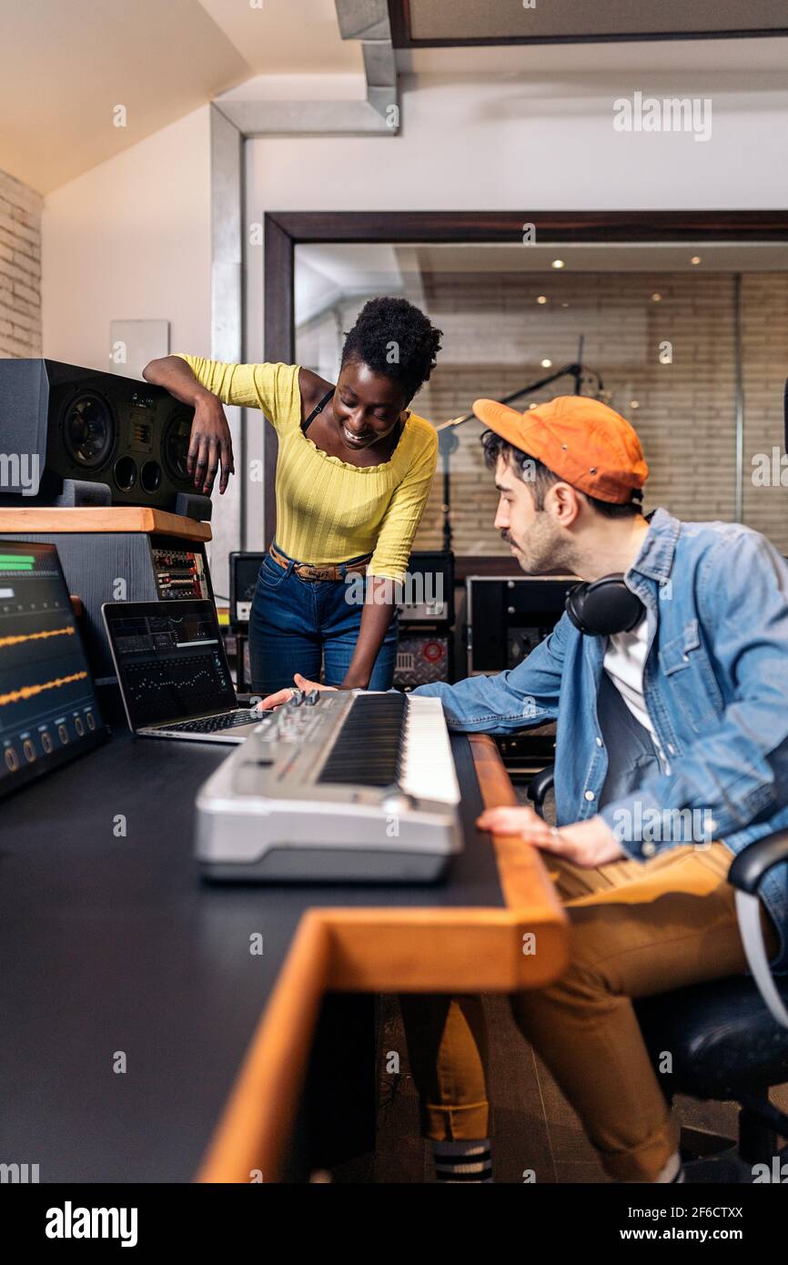 Stock photo of black woman working with male producer in music studio ...