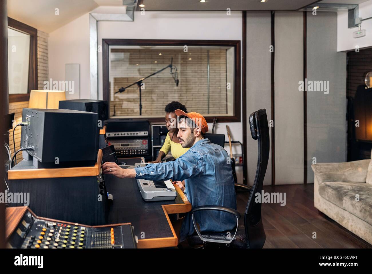 Stock photo of black woman working with male producer in music studio ...