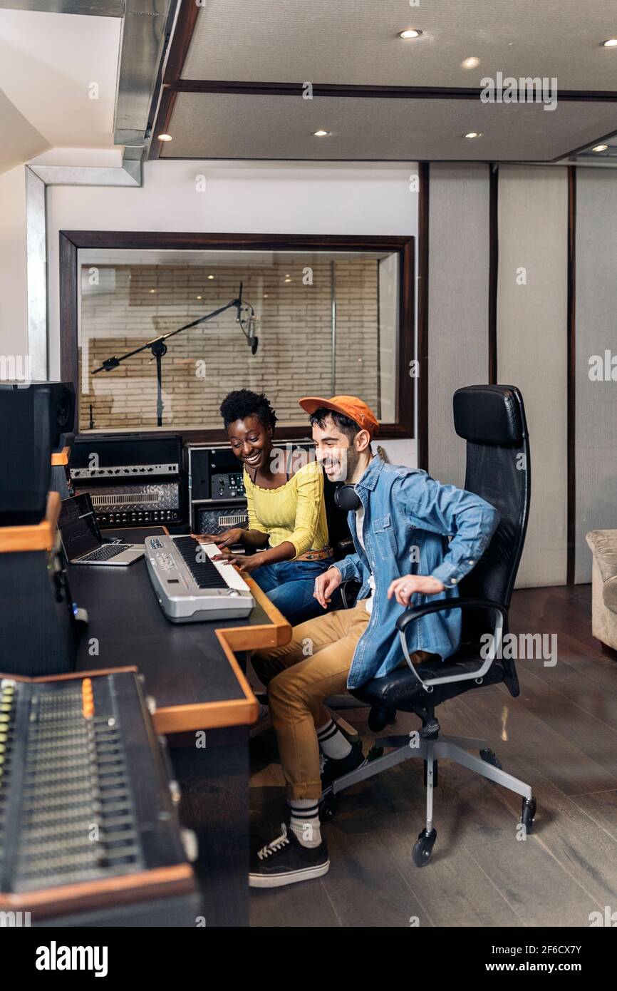Stock photo of black woman working with male producer in music studio ...