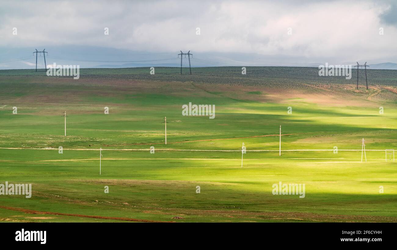 Green field with sun shadow patterns Stock Photo - Alamy