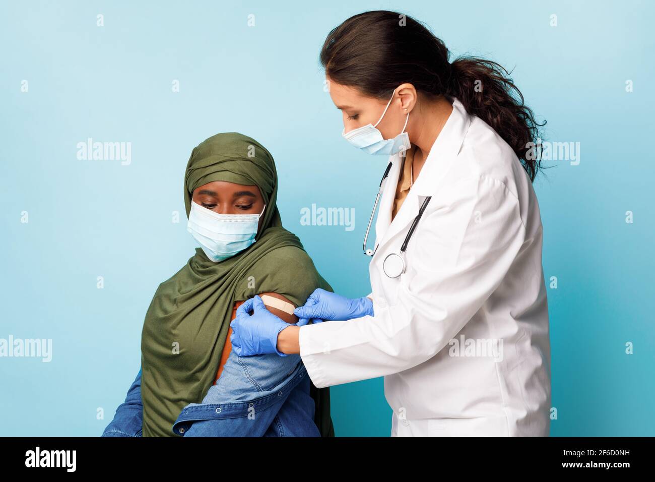 Nurse Vaccinating Muslim Female Applying Plaster On Vaccinated Arm ...