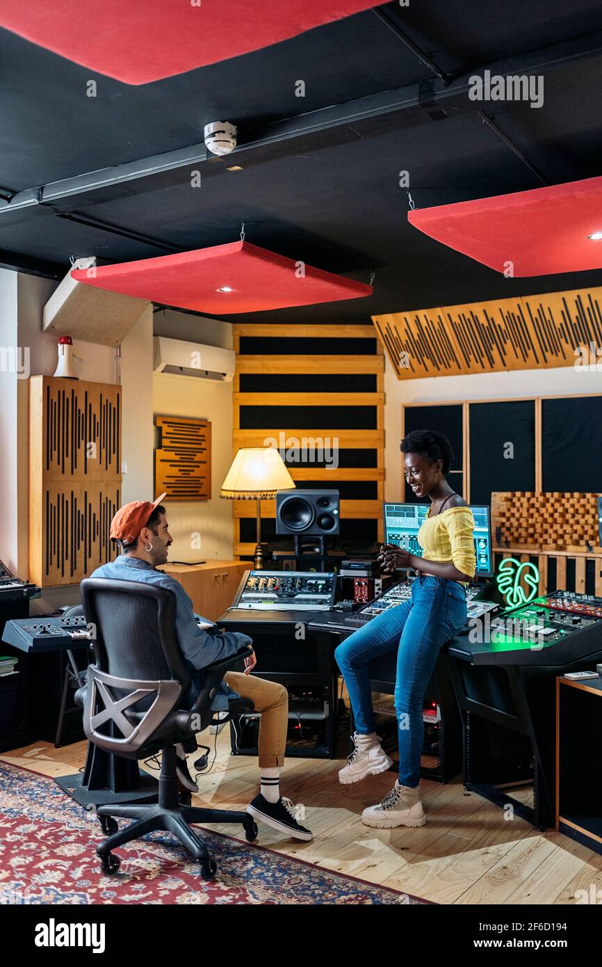 Stock photo of music producer and black singer talking in the music ...