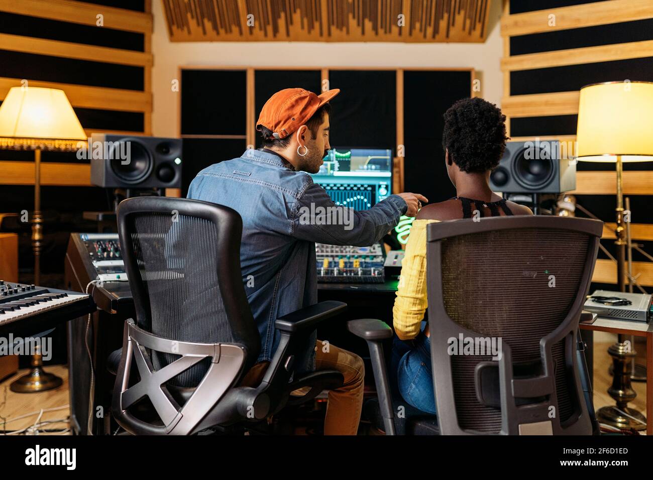Stock photo of male music producer working with black singer in ...