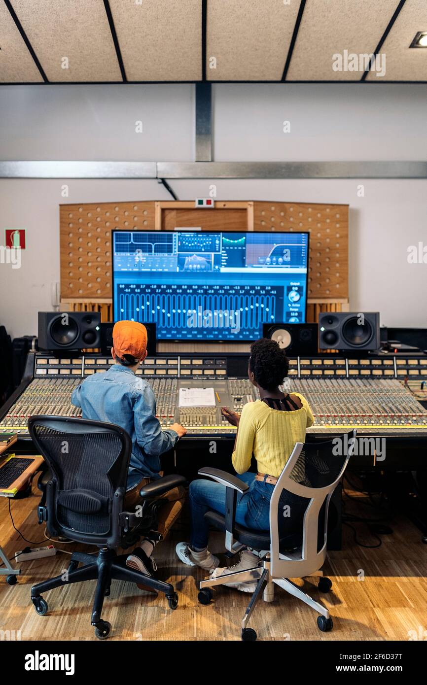 Stock photo of male music producer working with black singer in ...