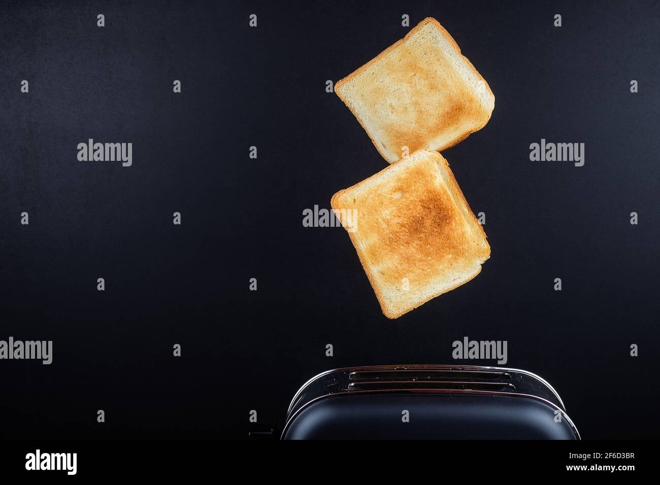 Bread coming out of the toaster with minimalist black background Stock ...