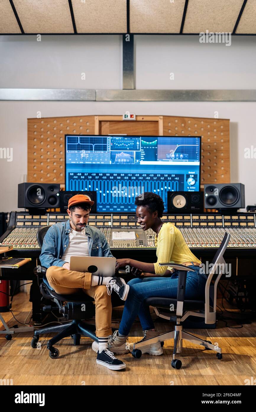 Stock photo of male music producer working with black singer in ...