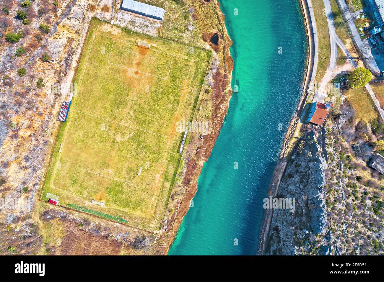 Obrovac. Soccer field by Zrmanja river aerial view. Karst landscape of ...
