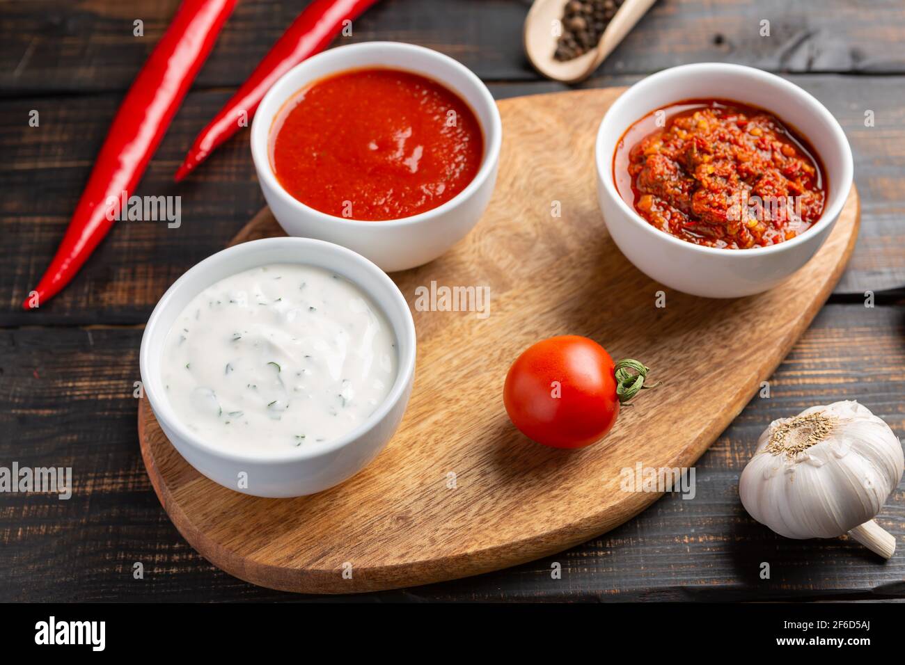 Variations of different types of sauces. On dark rustic background ...
