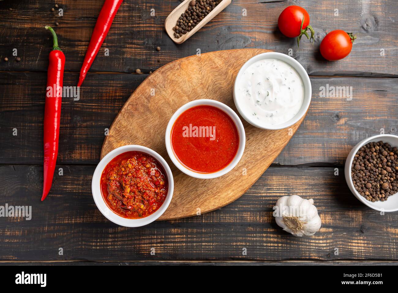 Variations of different types of sauces. On dark rustic background ...
