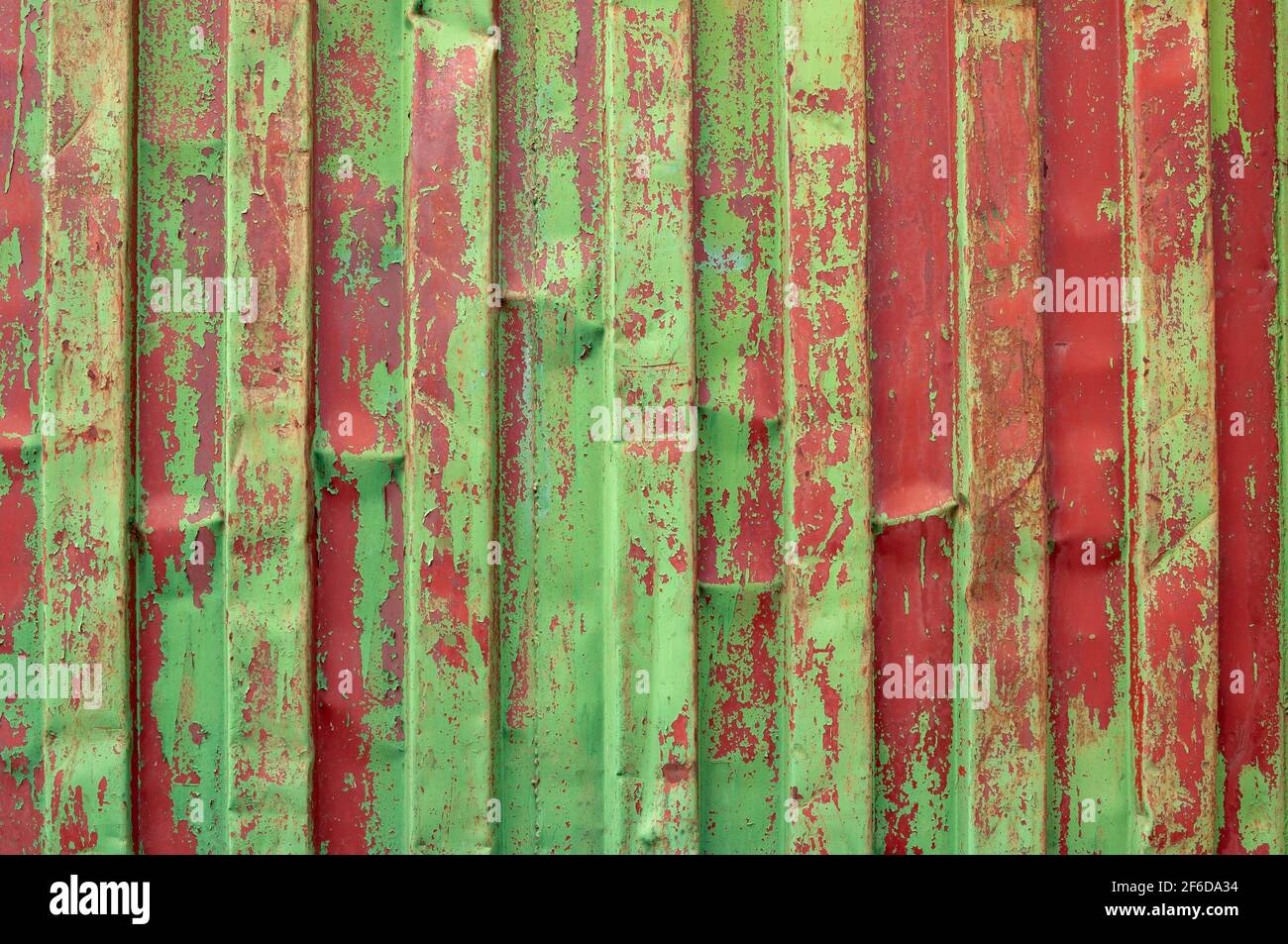 Corrugated metal cladding surface, painted in green and red. Old ...