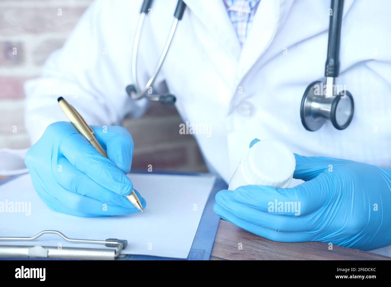 Doctor sitting desk taking notes hi-res stock photography and images ...