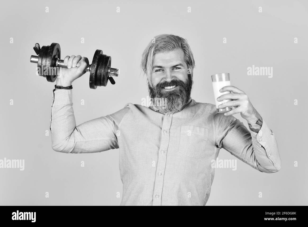 Source of calcium. Bearded man drink milk. Exercise in gym. Milk good ...