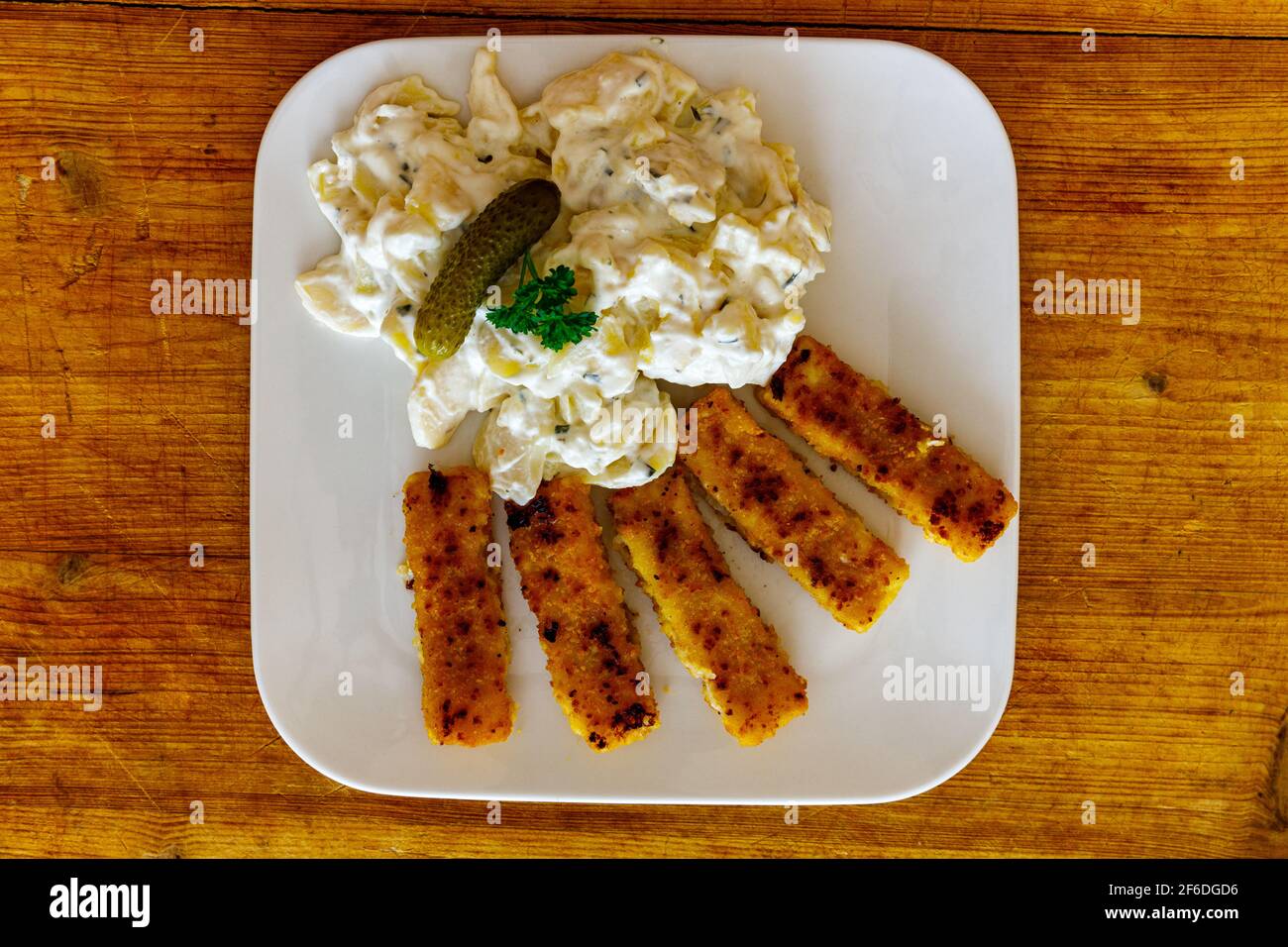 Fish sticks with potato salad Stock Photo - Alamy