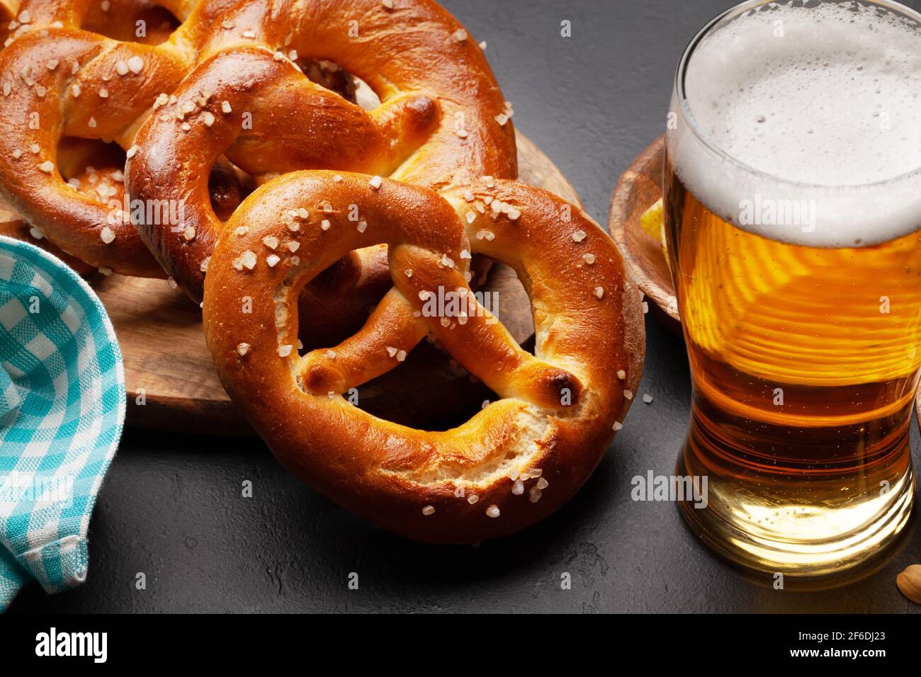 Lager beer mug and fresh baked homemade pretzel with sea salt on stone ...