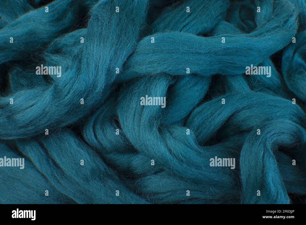 Pretty teal blue merino wool lying in loose stings ready to be used ...