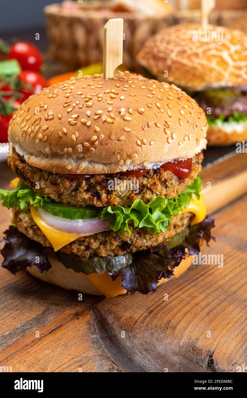Tasty vegetarian cheeseburgers and hamburgers with round patties or ...