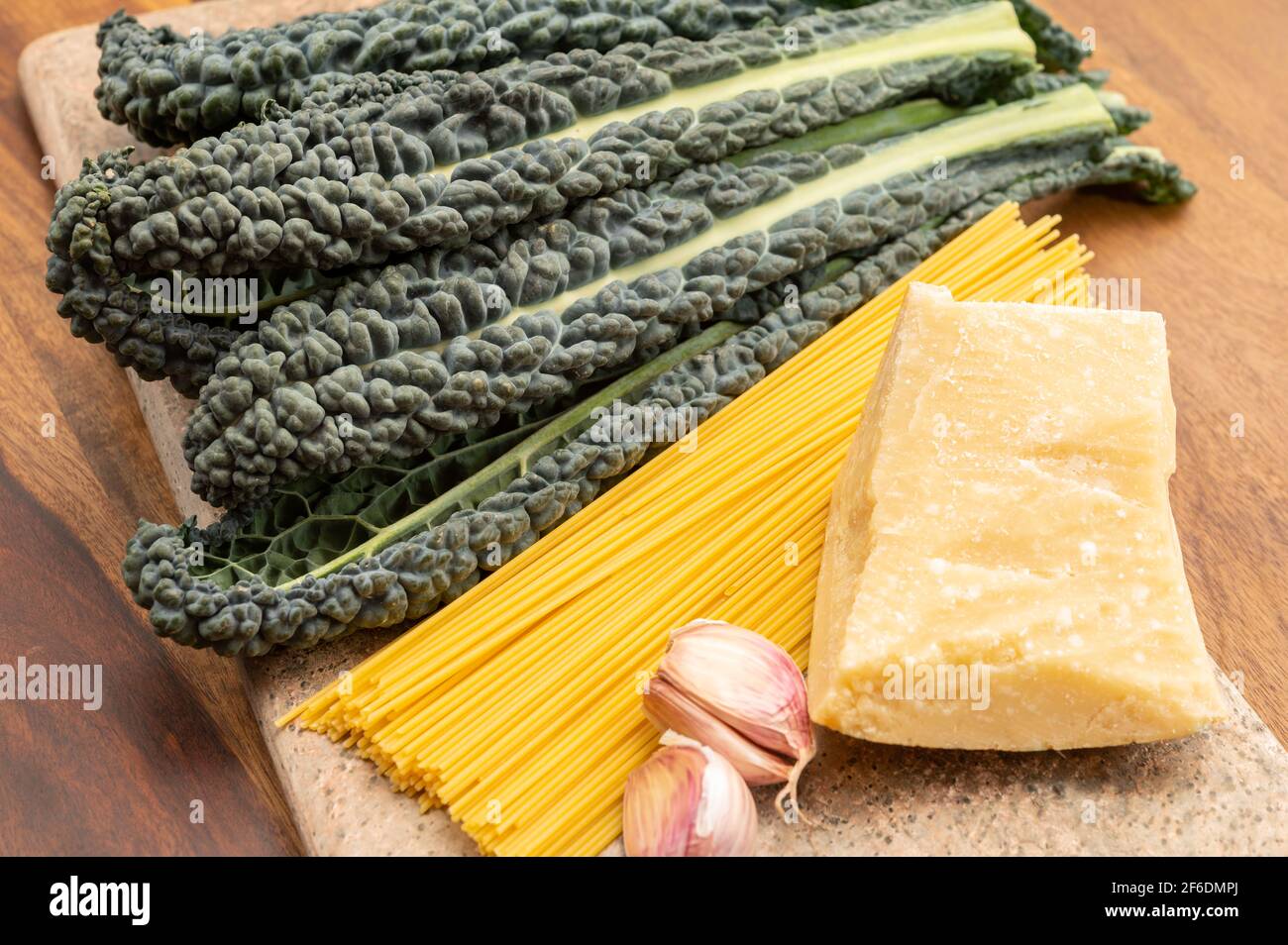 Vegetarian cooking with black flat leaves of cavolo nero tuscan cabbage ...
