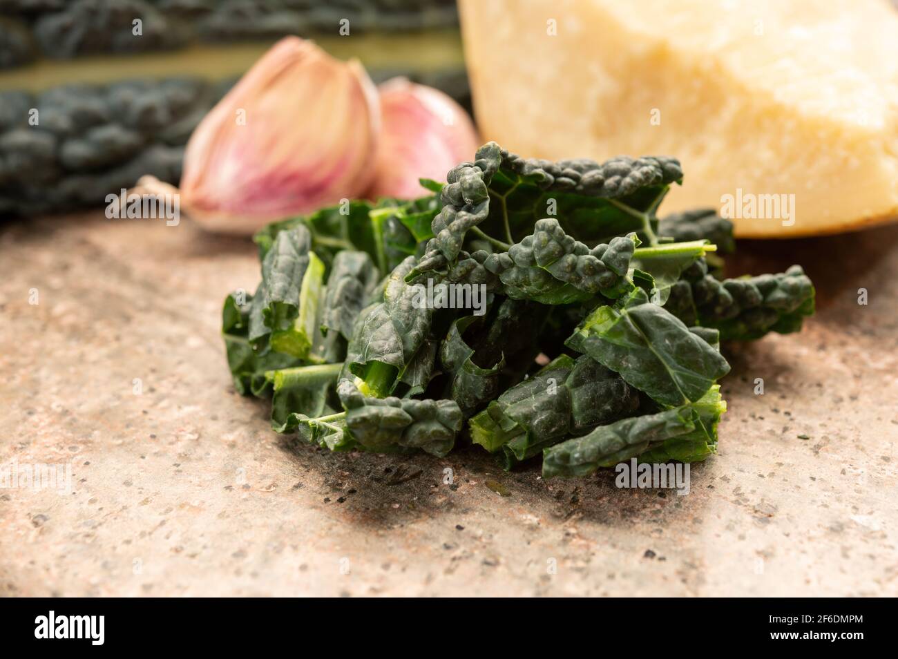 Vegetarian cooking with black flat leaves of cavolo nero tuscan cabbage ...