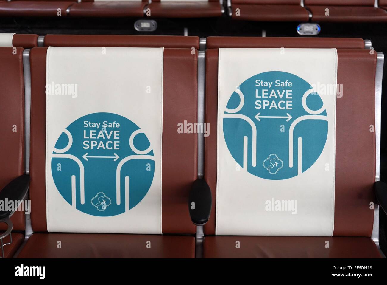 Physical and social distancing marker signs with the words "Stay Safe ...