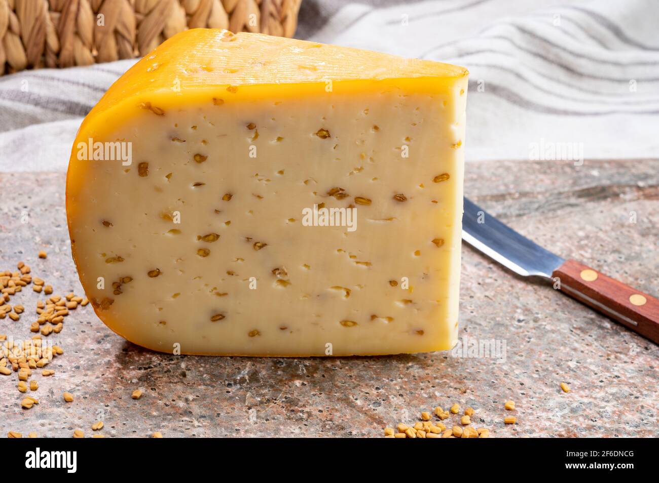 Cheese collection, piece of hard yellow Dutch gouda cheese with dried ...