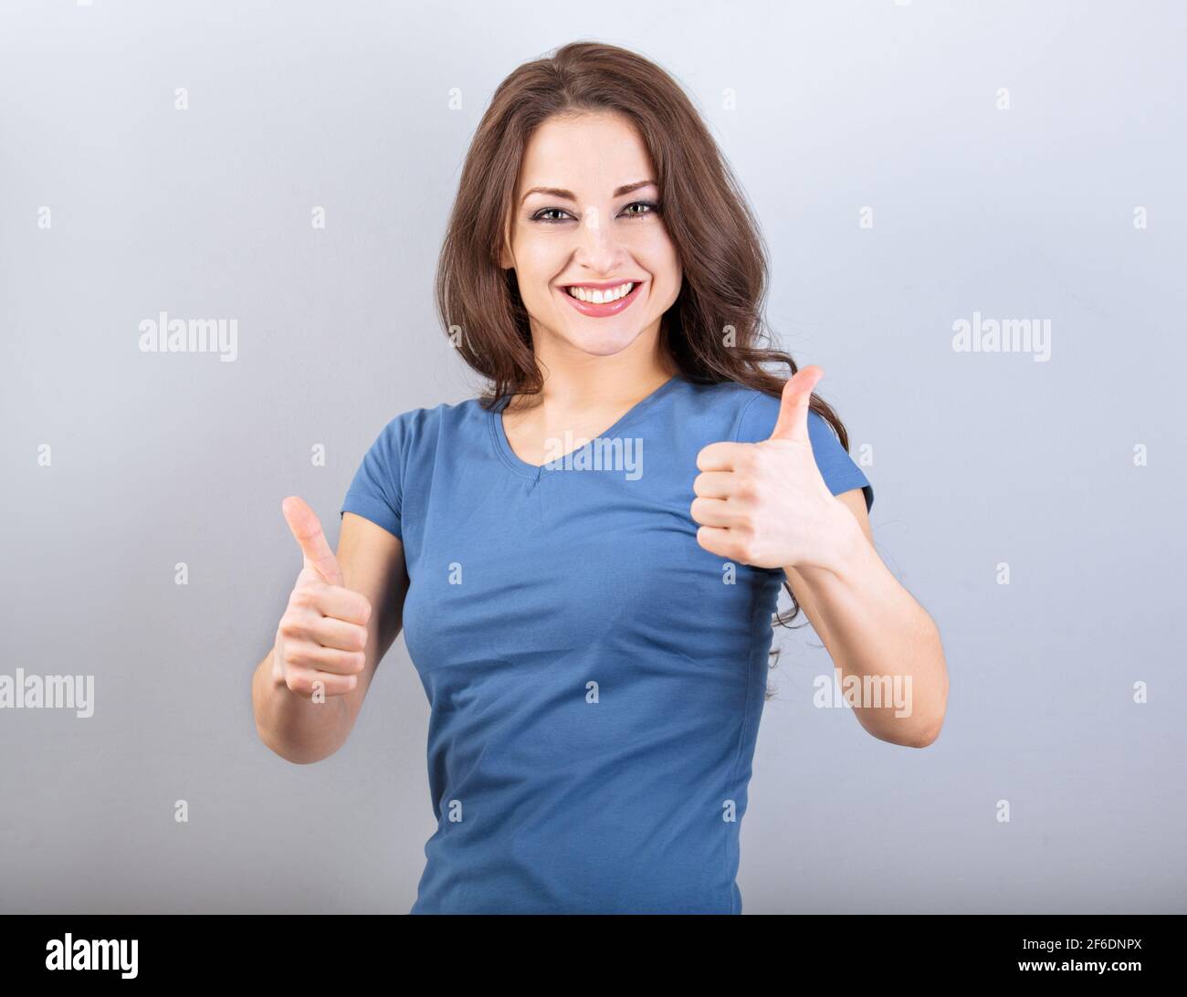 Beautiful long hair and wide toothy smile woman showing fingers thumb ...