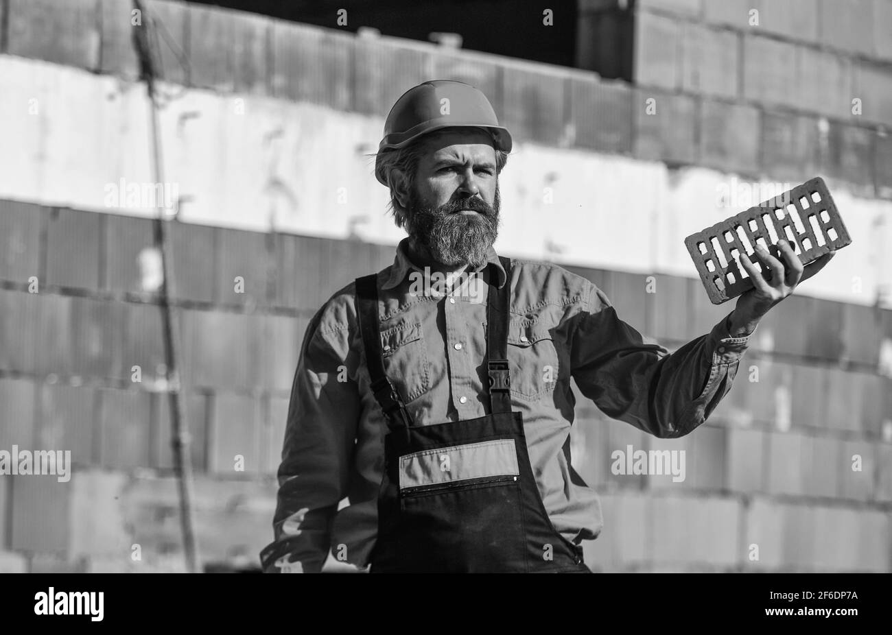 brickwork. Man takes brick from the pile. Male construction worker ...