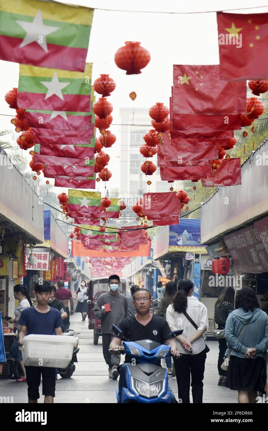 National flags of China and Myanmar are seen in Ruili in China's Yunnan ...