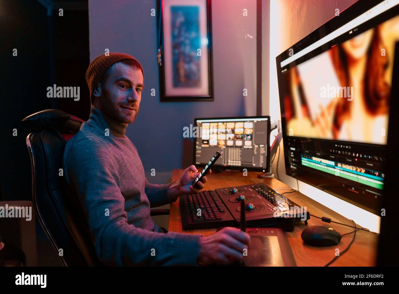 Attractive Male Video Editor Works with Footage or Video on His ...