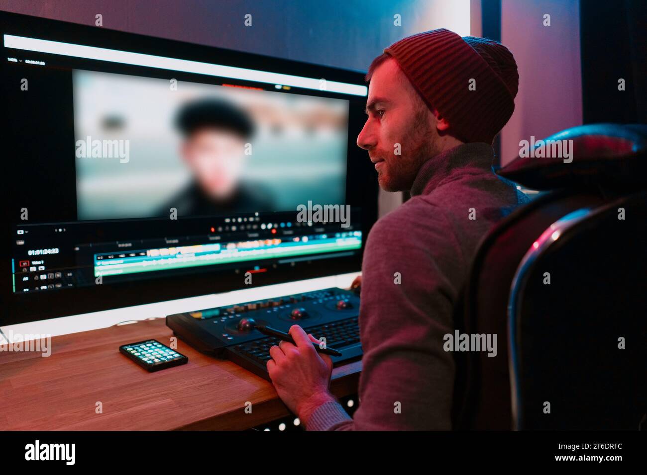 Attractive Male Video Editor Works with Footage or Video on His ...