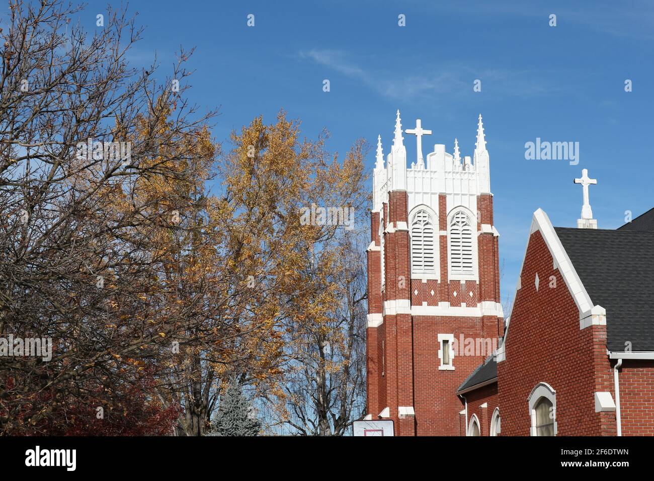 A church bell tower with fall colors and blue sky in small town Oregon ...