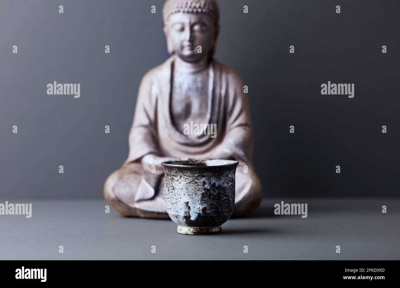Traditional, handcrafted ceramic on dark background. Meditating Buddha ...