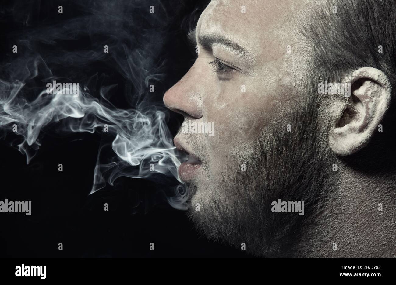 Portrait of the man in smoke and dust Stock Photo - Alamy