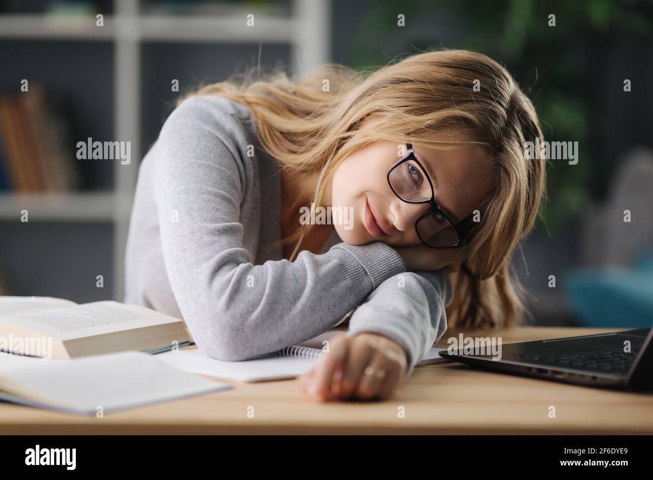 Student resting on table Stock Photo - Alamy