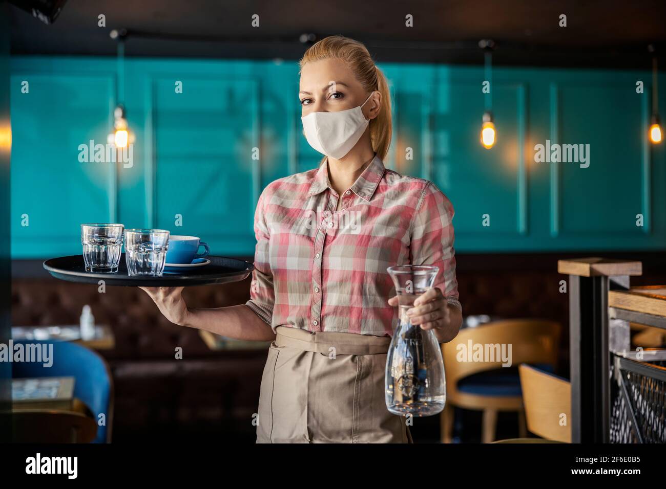Serving coffee and water during the corona virus. Portrait of a ...