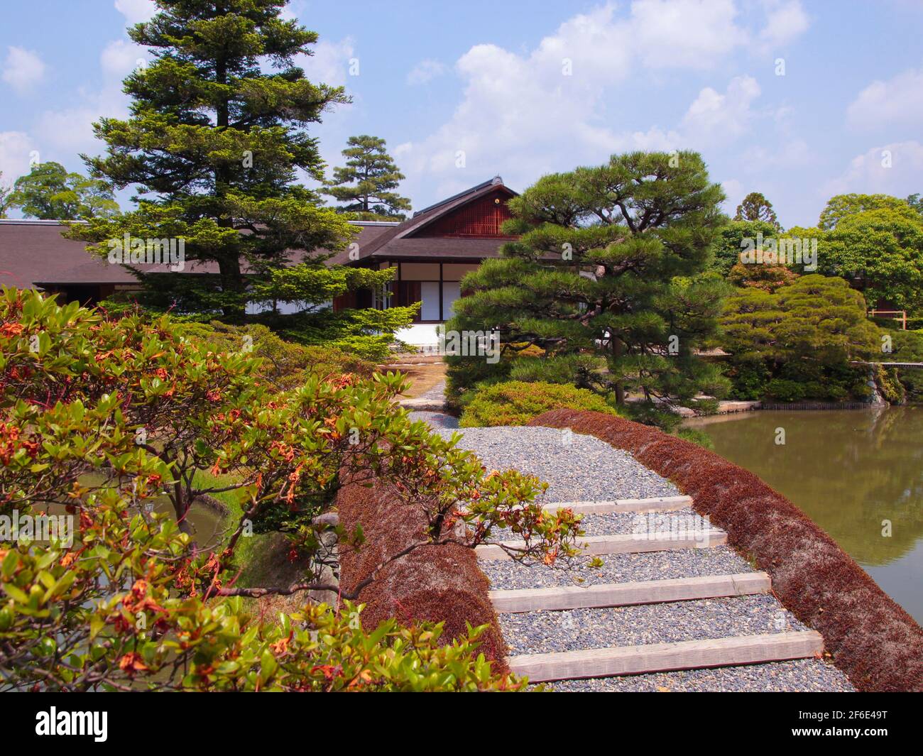 The view of the gardens with curved, arched walkway bridge. At Hachijō ...