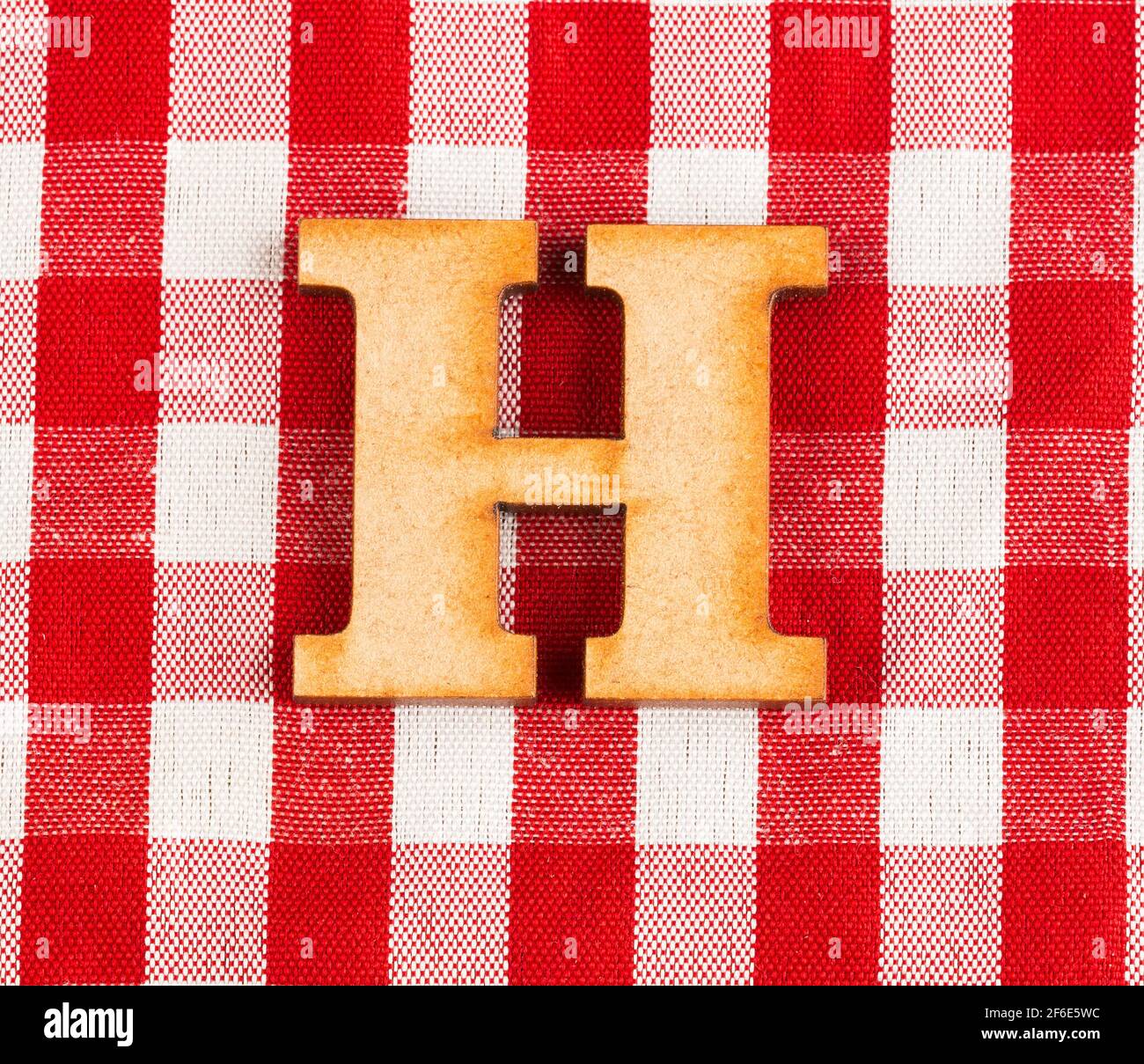 Letter H of the alphabet - Red checkered fabric tablecloth Stock Photo ...