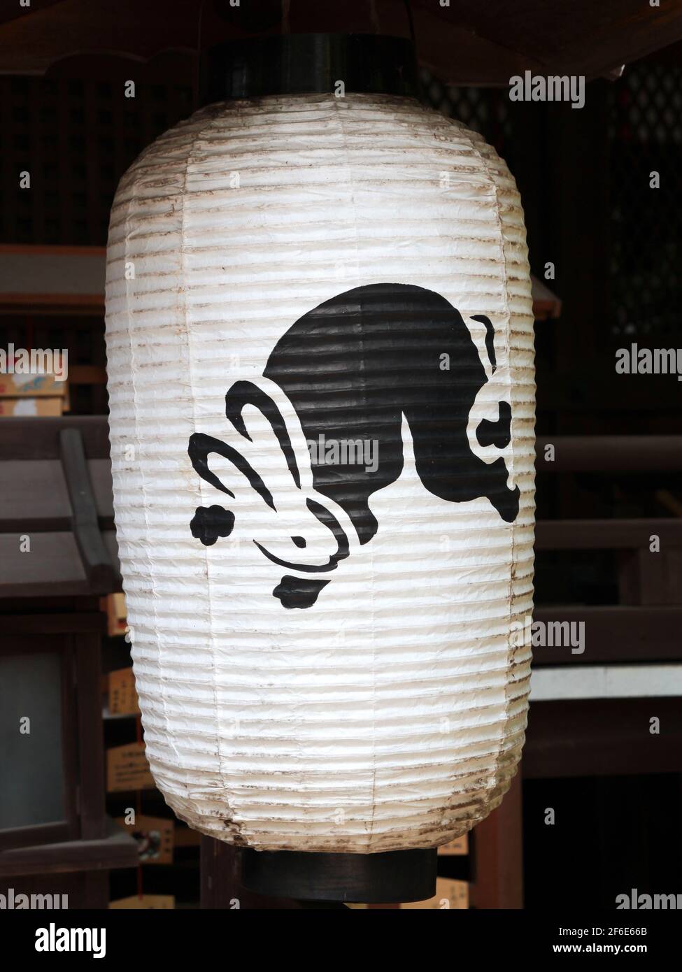 A rice paper lantern with a black bunny rabbit drawing on it. At the ...